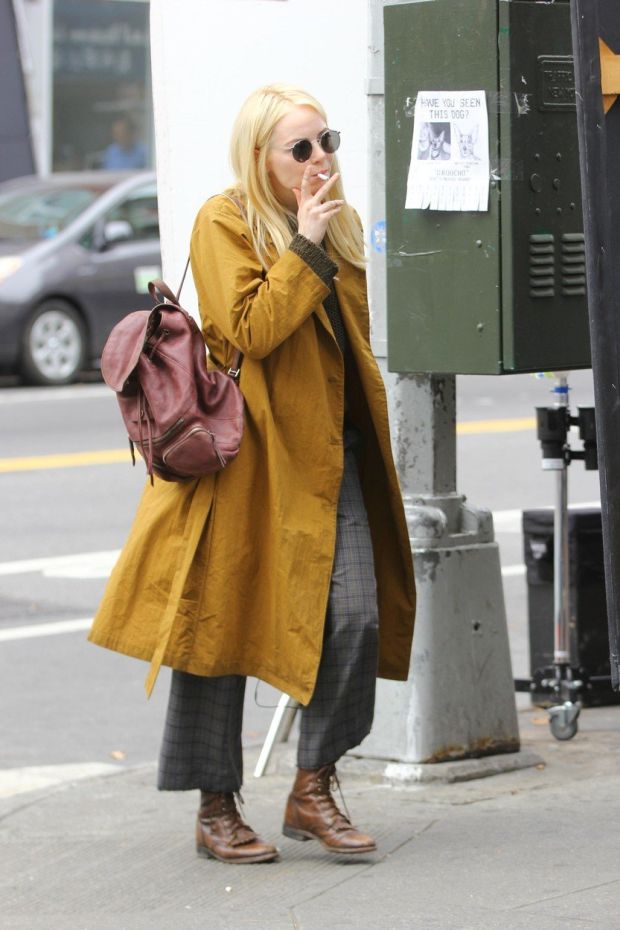 A blonde haired Emma Stone smokes a cigarette on the set of new Netflix ...